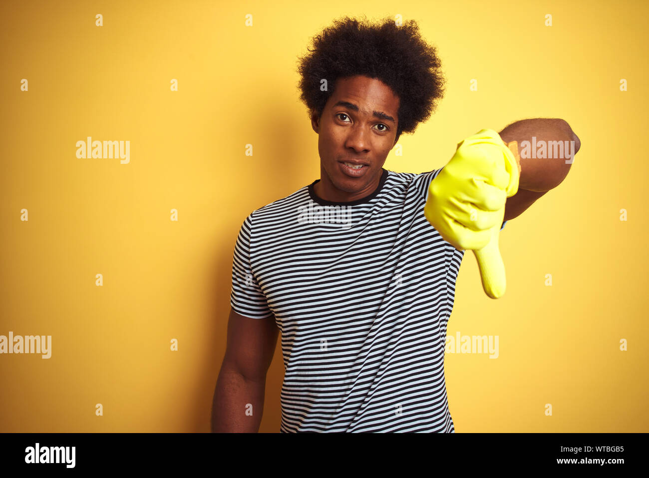 Young african american man cleaning using gloves standing over isolated ...