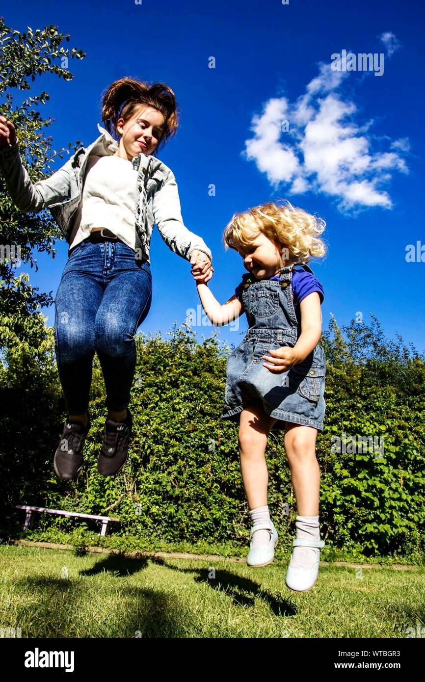 Jumping holding hands hi-res stock photography and images - Alamy