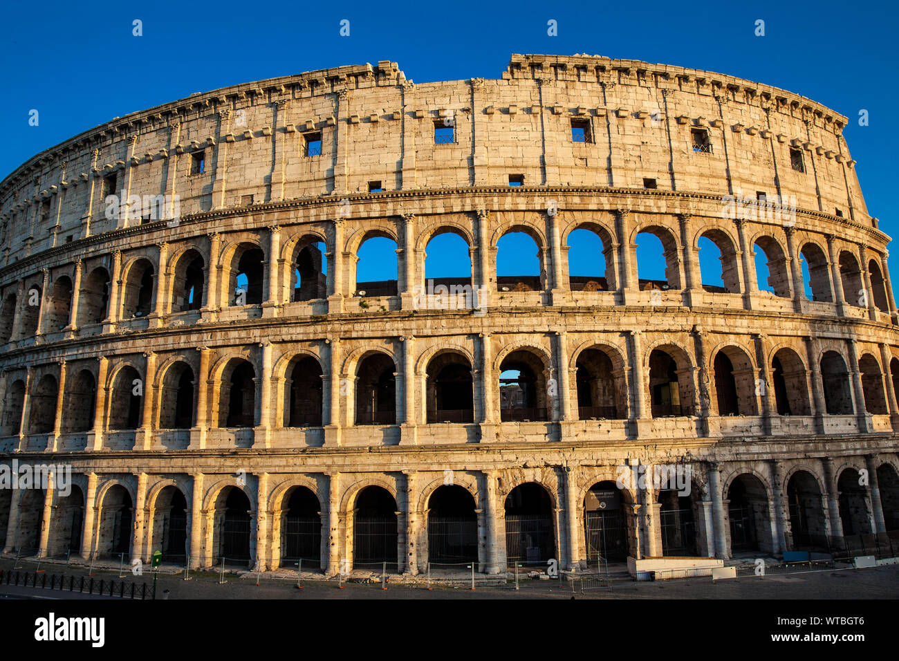 The famous Colosseum under the beautiful light of the golden hour in ...