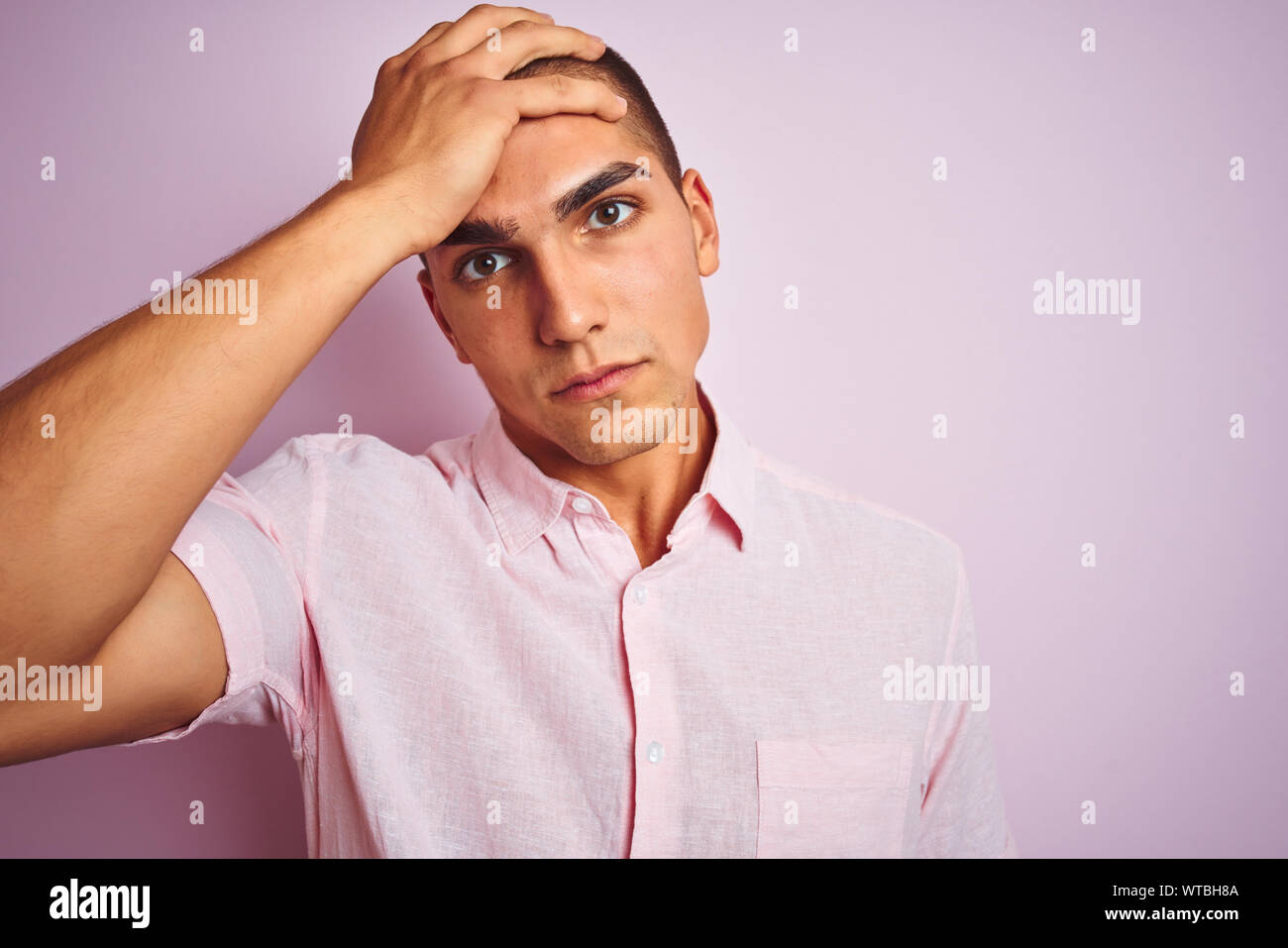 Young handsome man wearing elegant shirt over pink isolated background ...