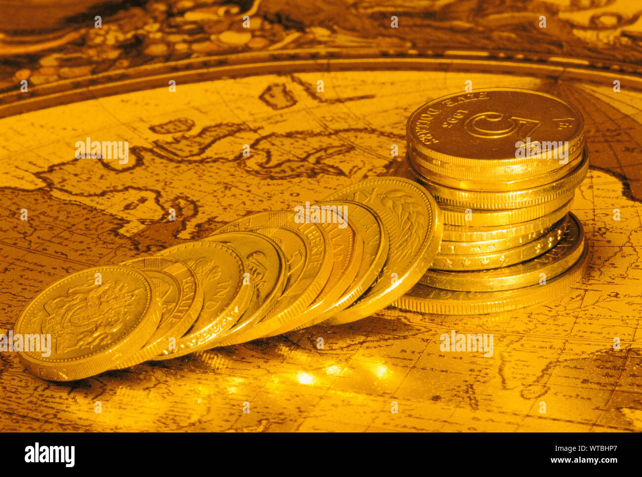 Stack of Coins Sitting on a Map Stock Photo - Alamy