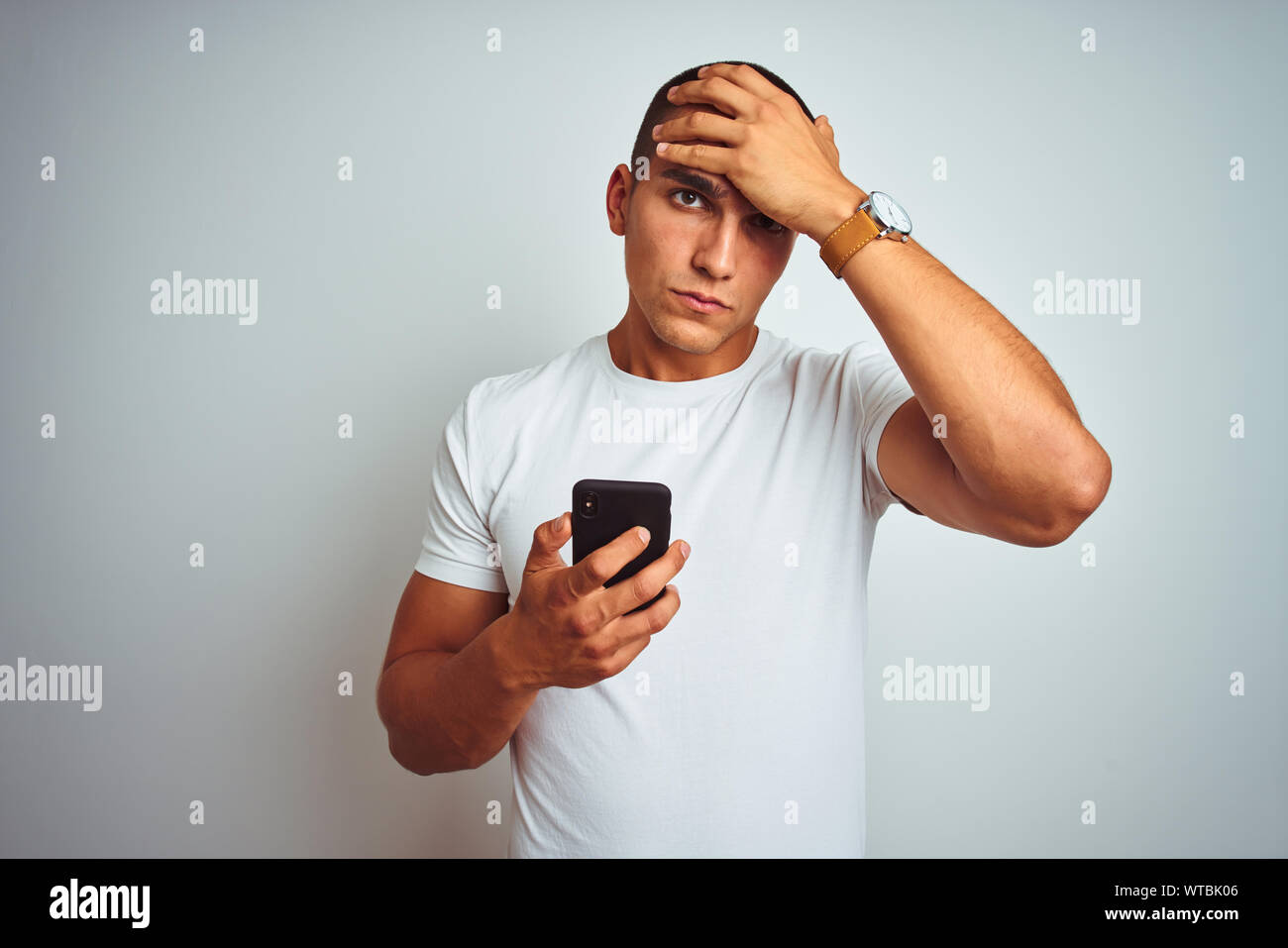 Young handsome man using smartphone over yellow isolated background ...