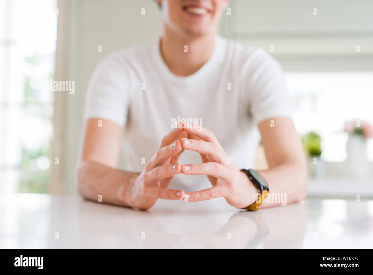 Close up young man hands together and smiling Stock Photo - Alamy