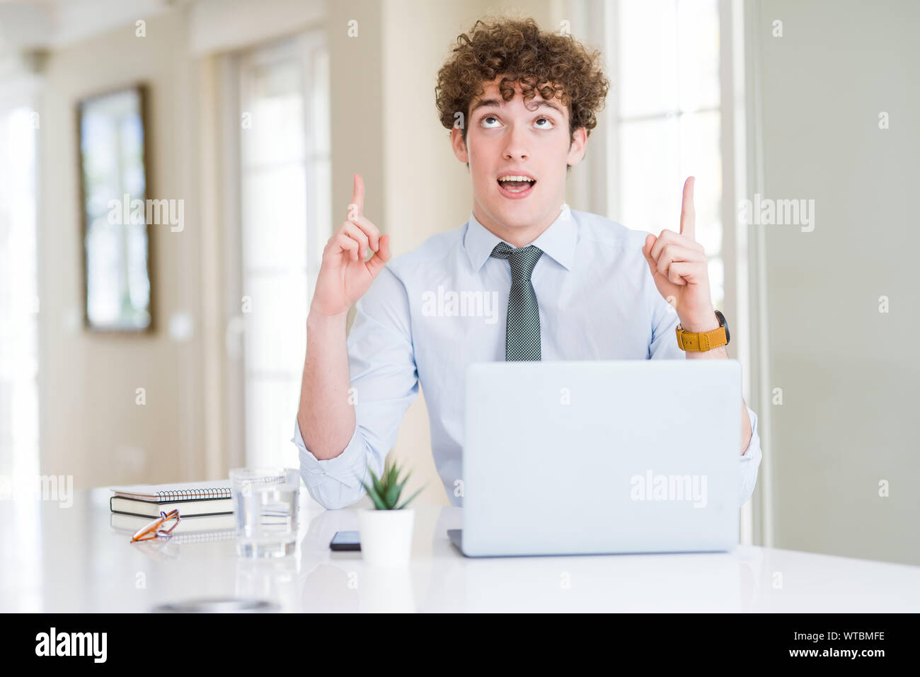 Young business man working with computer laptop at the office amazed ...