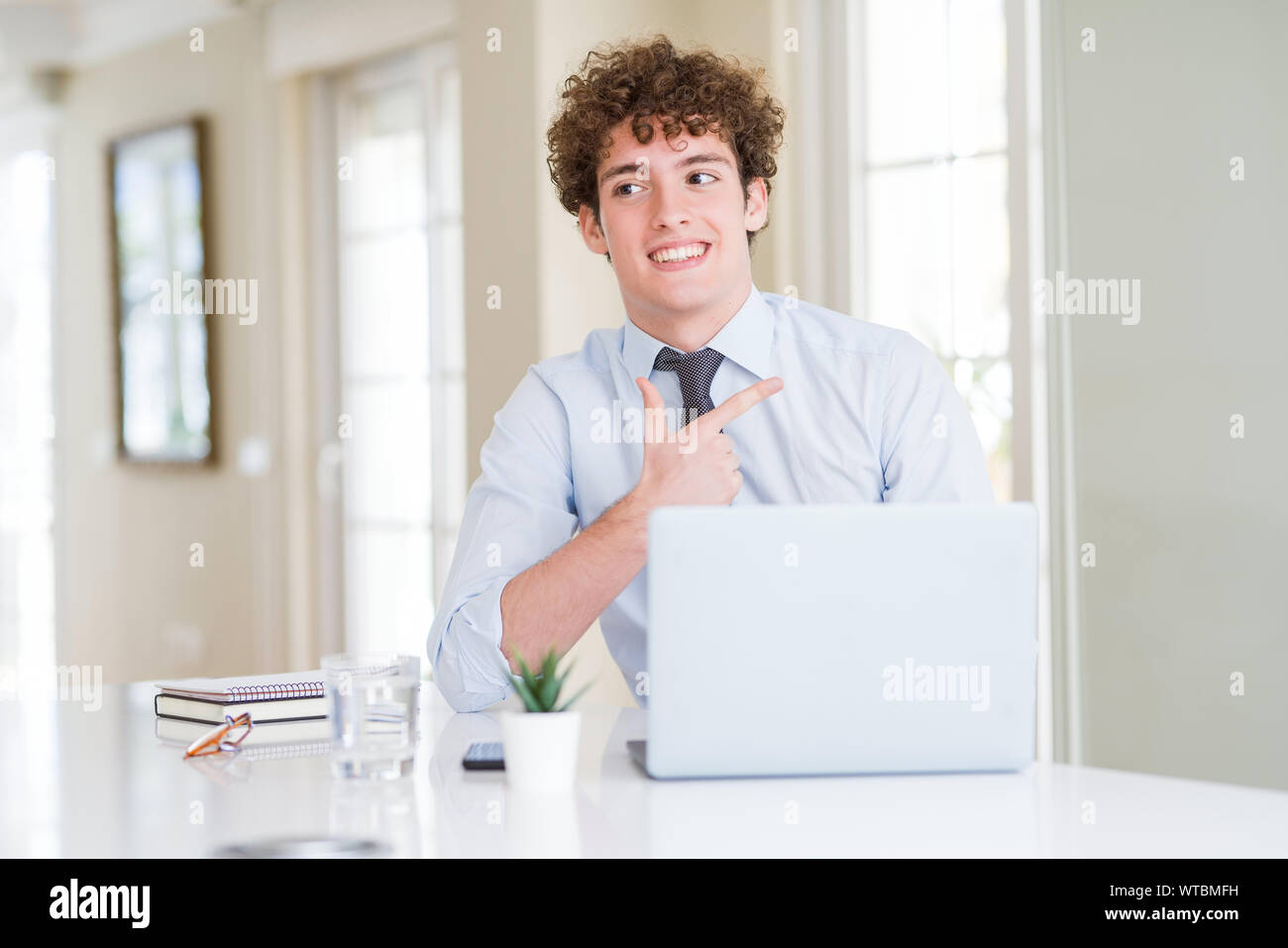 Young business man working with computer laptop at the office cheerful ...