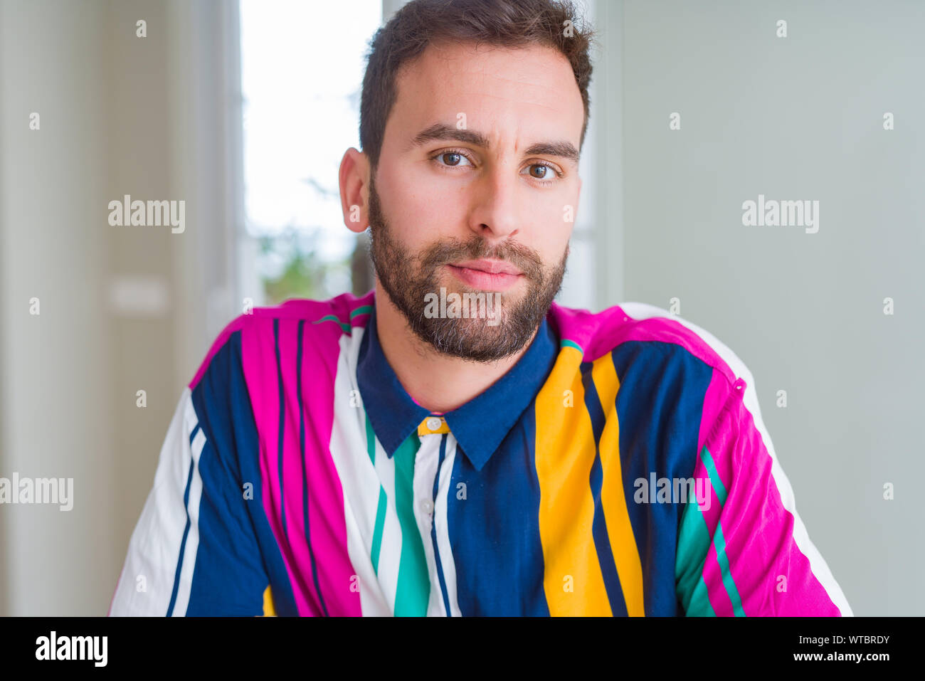 Handsome man looking relaxed at the camara Stock Photo - Alamy