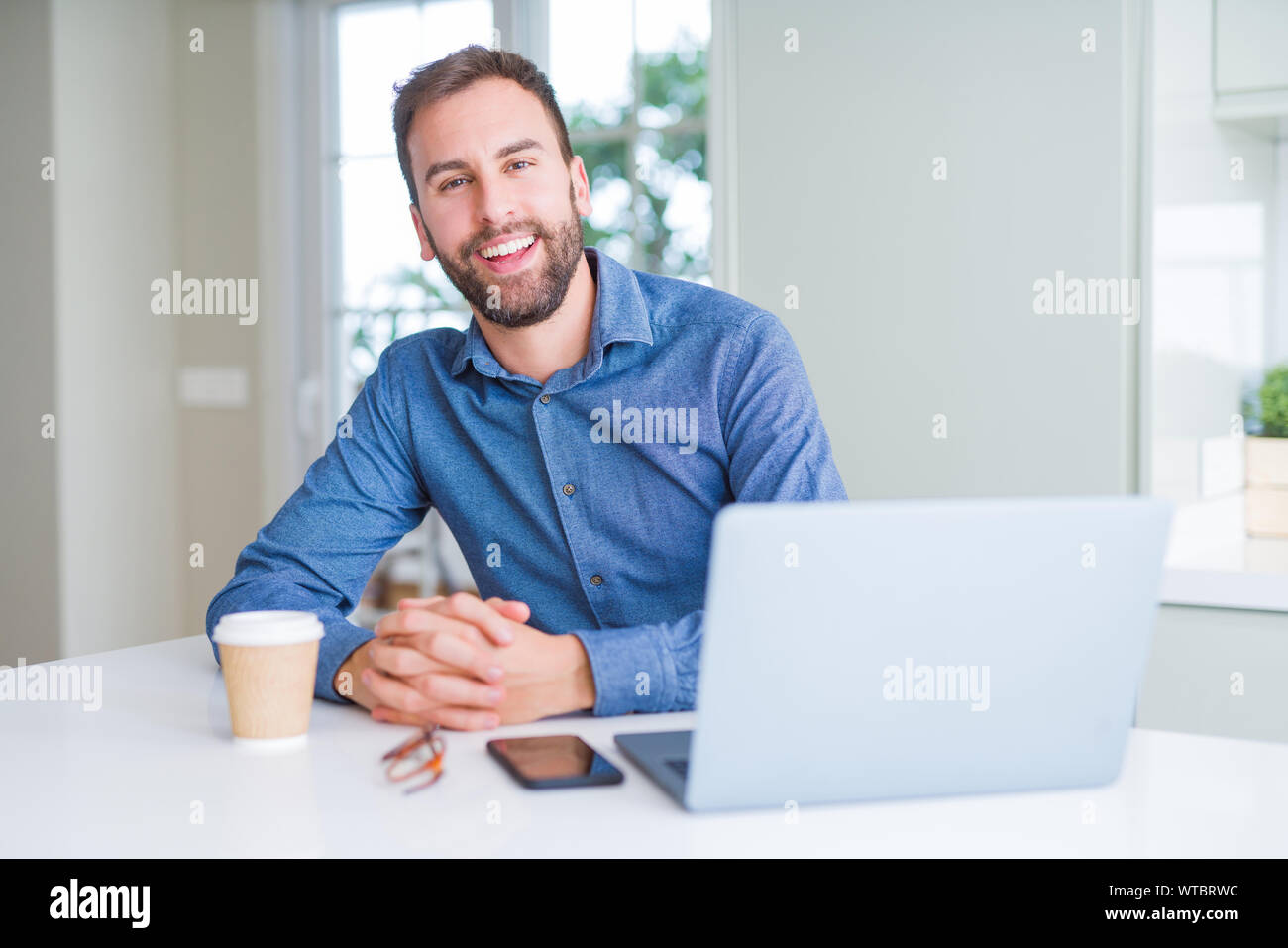 Handsome business man working using computer laptop and smiling Stock ...