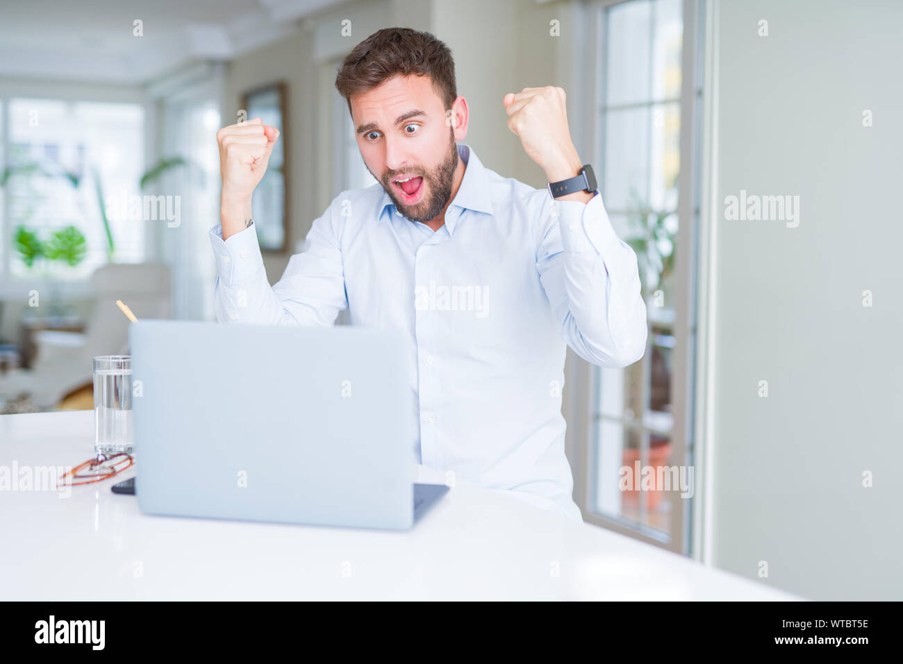 Business man eating take away asian noodles food while working using ...