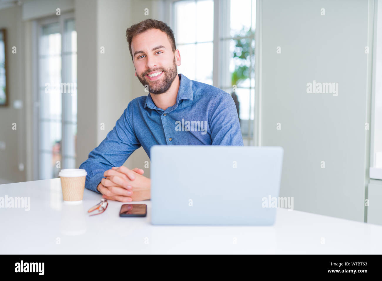Handsome business man working using computer laptop and smiling Stock ...
