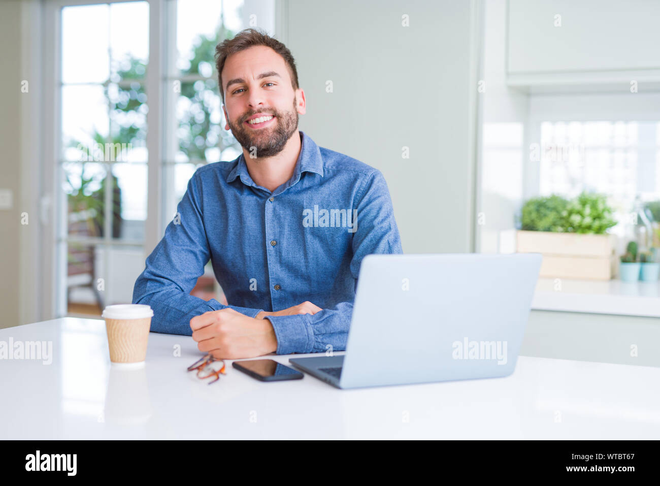 Handsome business man working using computer laptop and smiling Stock ...