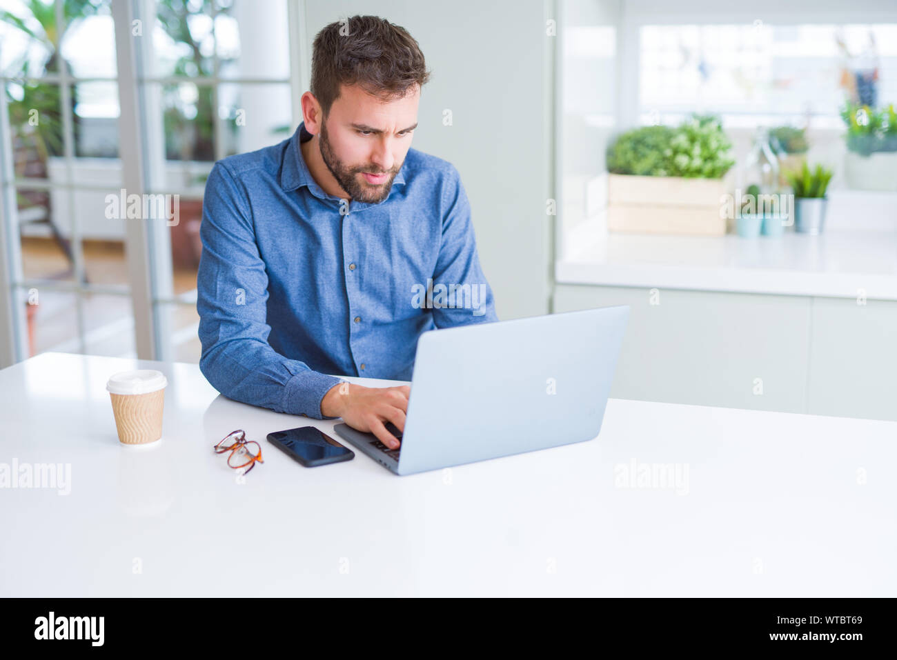 Handsome business man working using computer laptop and smiling Stock ...