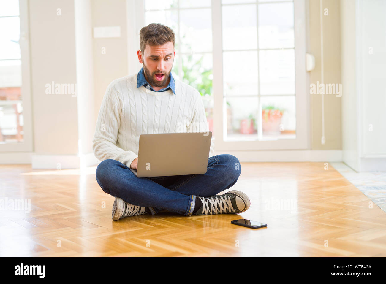 Shocked man in disbelief sitting hi-res stock photography and images ...