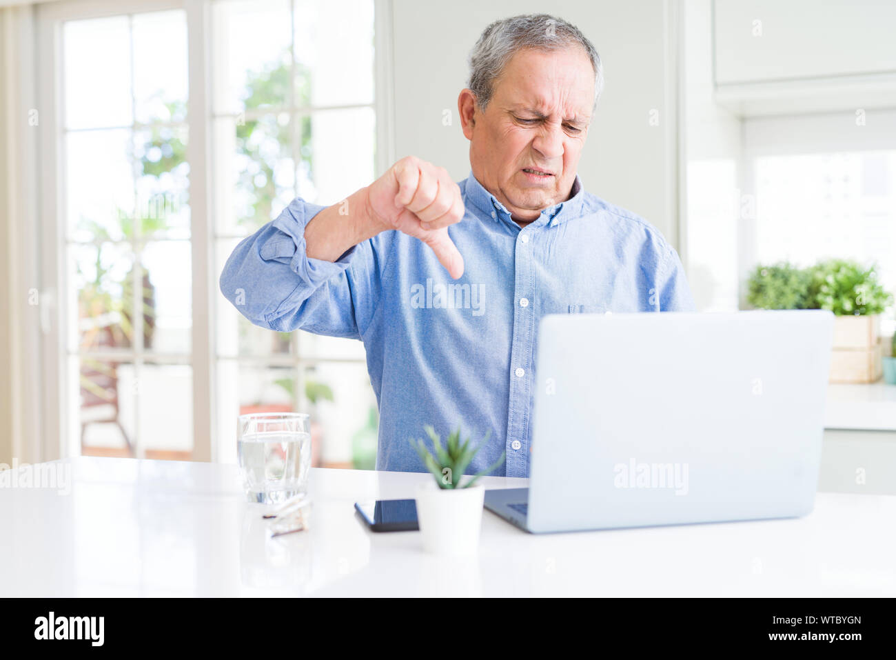 Handsome senior man using computer laptop working on internet with ...