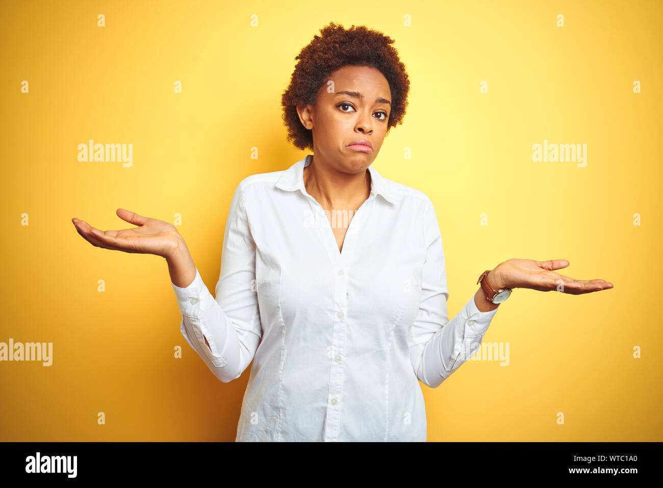 African american business woman over isolated yellow background ...
