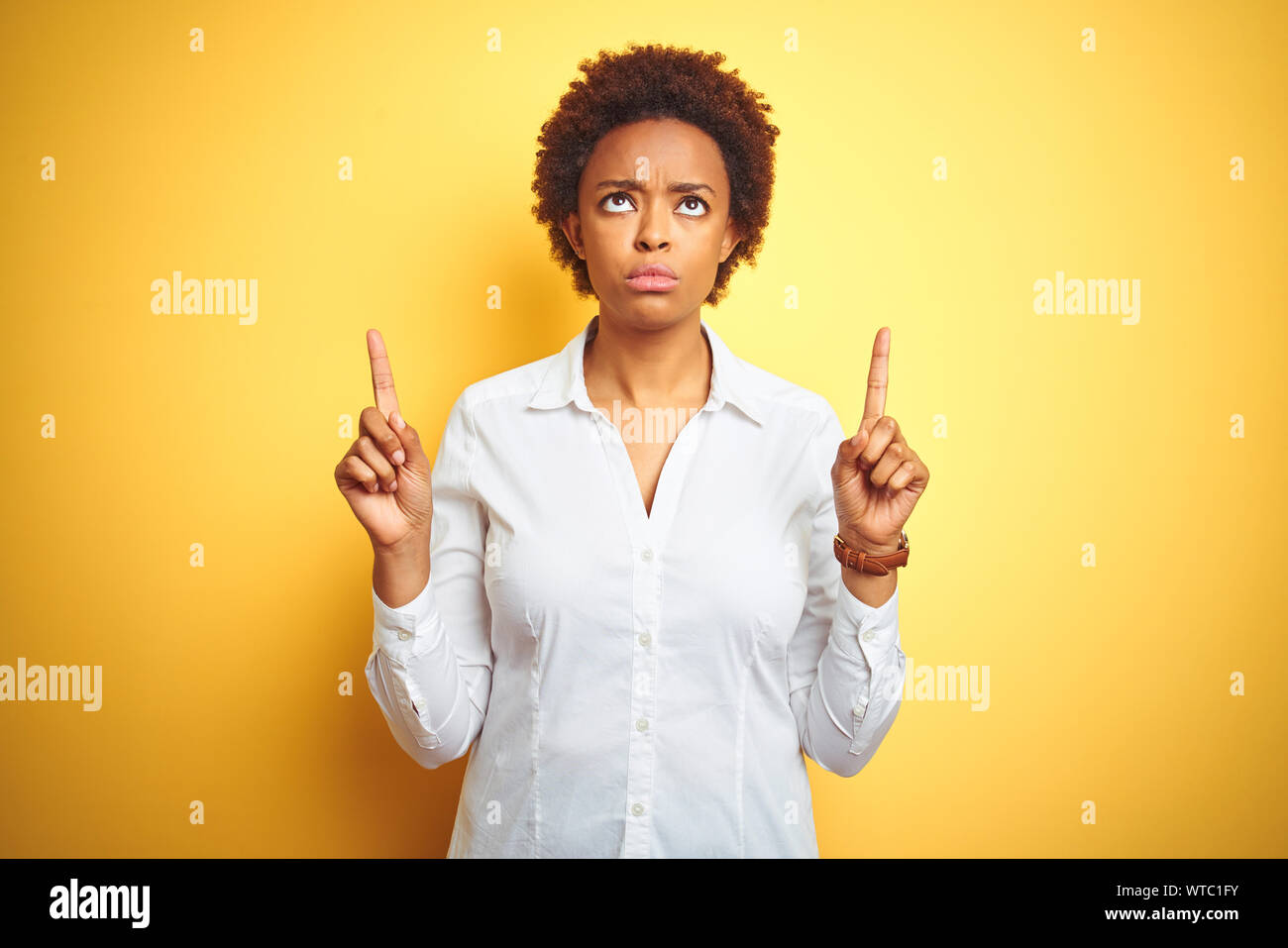 African american business woman over isolated yellow background ...
