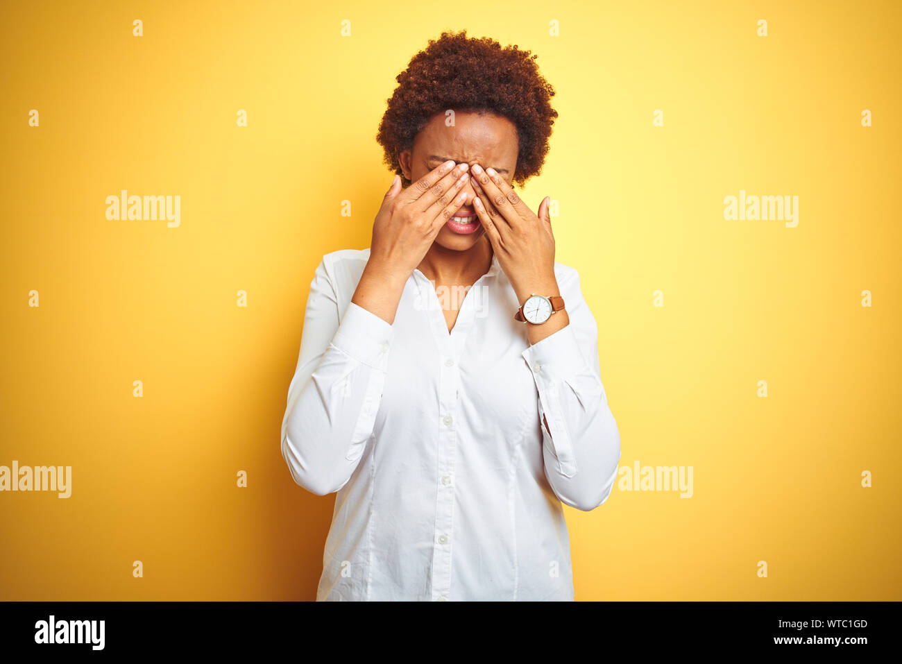 African american business woman over isolated yellow background rubbing ...