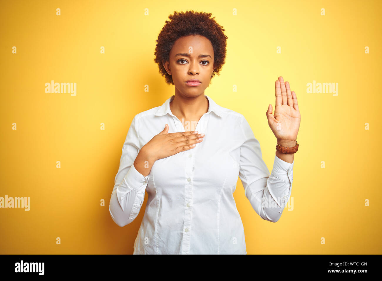 African american business woman over isolated yellow background ...