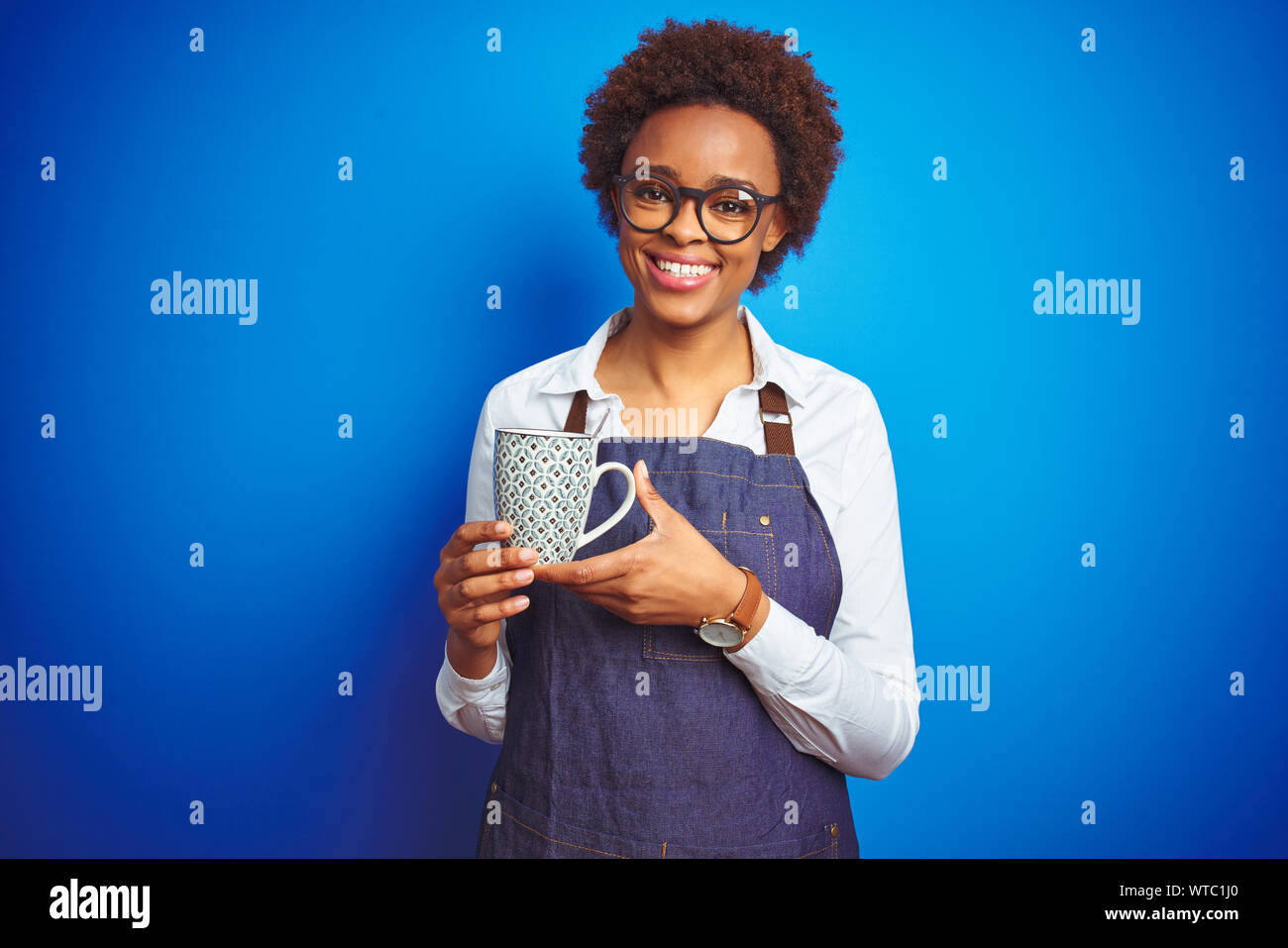 African american barista woman wearing bartender uniform holding cup ...