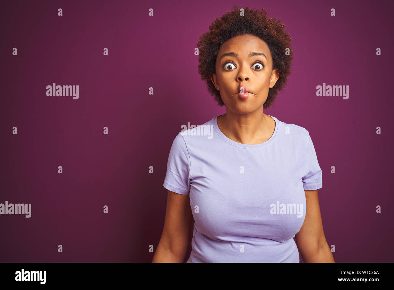 Young beautiful african american woman with afro hair over isolated ...