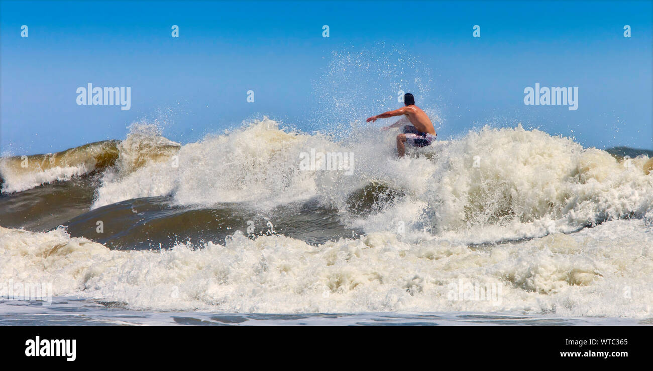 surfer riding out huge breaker Stock Photo - Alamy