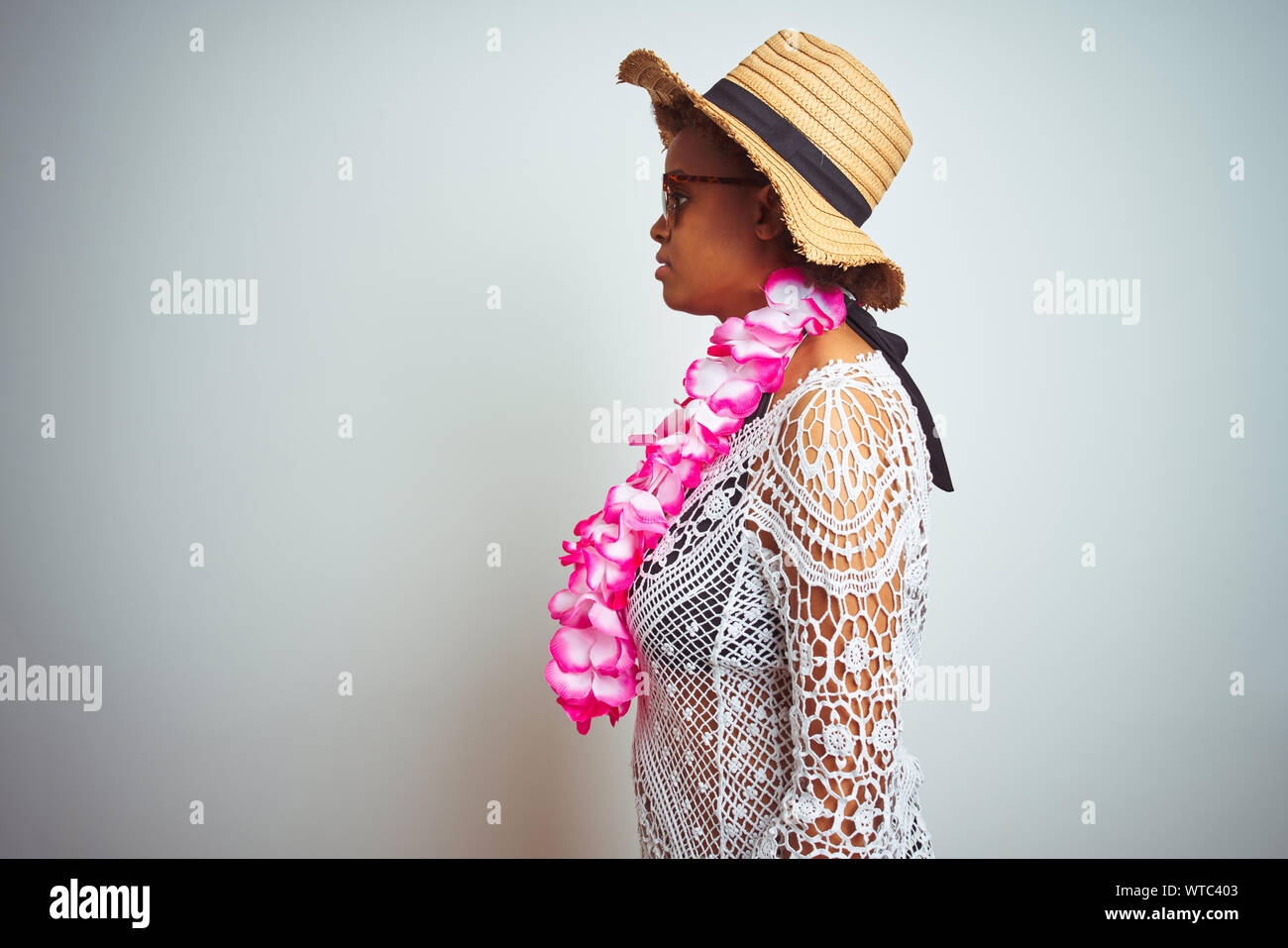 Young african american woman with afro hair wearing flower hawaiian lei ...