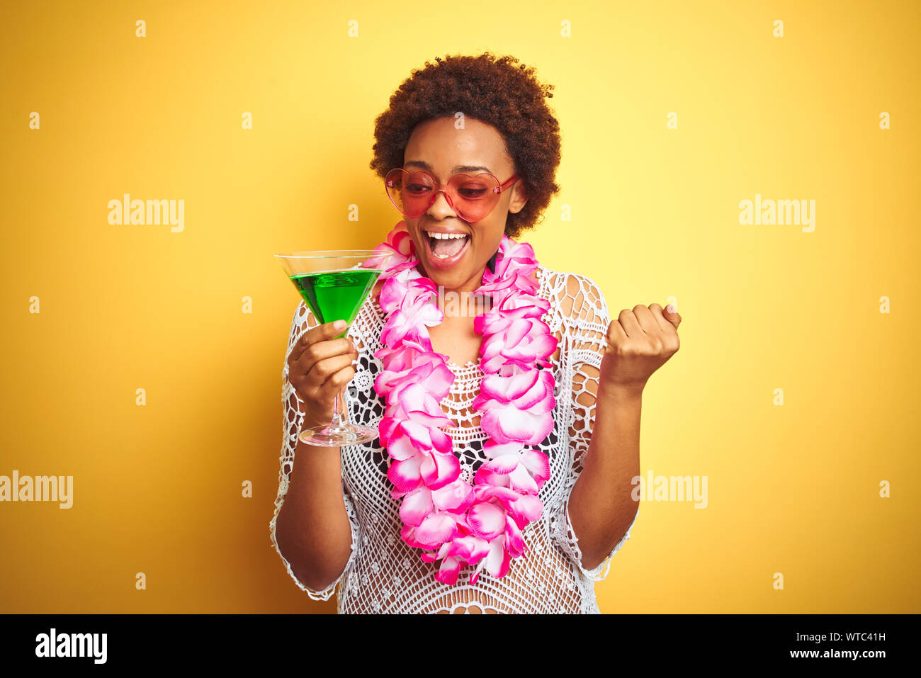 Young african american woman with afro hair wearing flower hawaiian lei ...