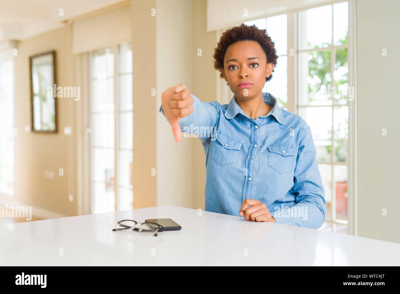Young beautiful african american woman looking unhappy and angry ...