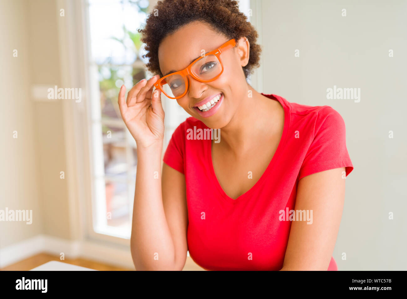 Beautiful young african woman with afro hair wearing glasses Stock ...