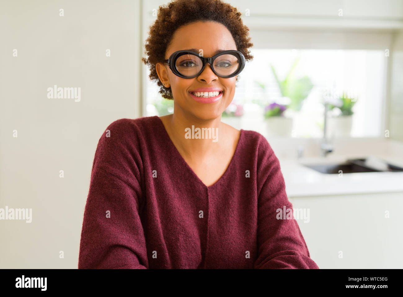Beautiful young african woman with afro hair wearing glasses Stock ...