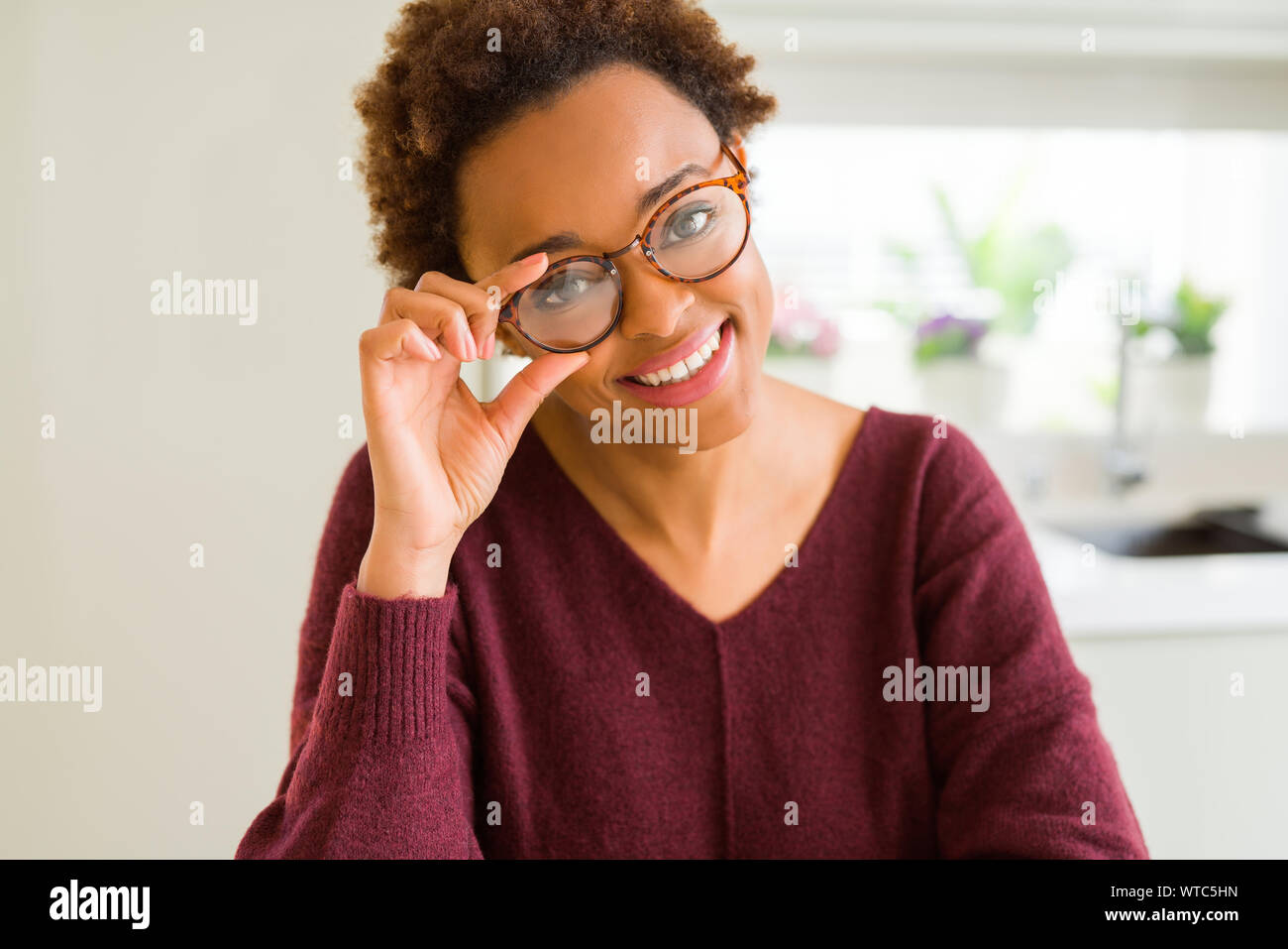 Beautiful young african woman with afro hair wearing glasses Stock ...