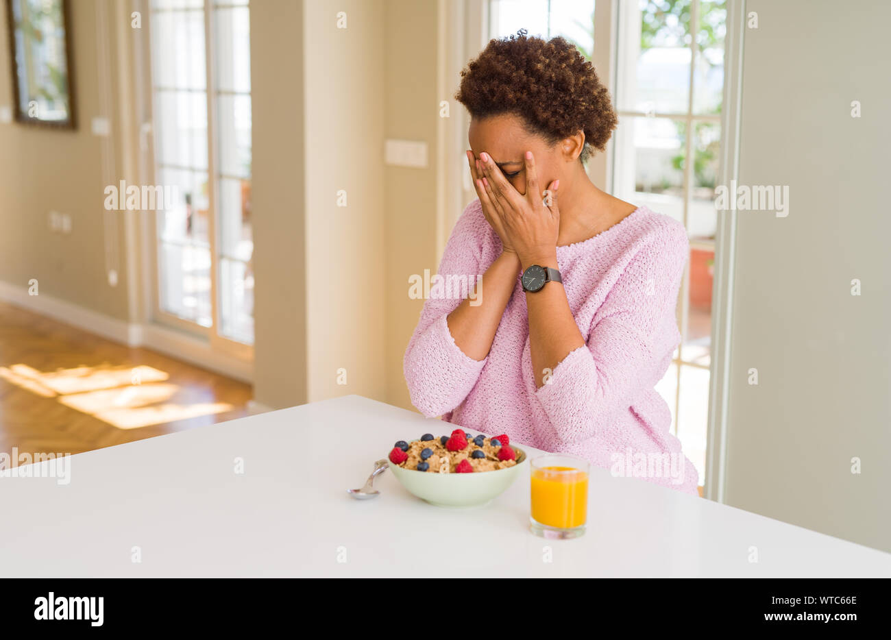 Young african american woman having healthy breakfast in the morning at ...
