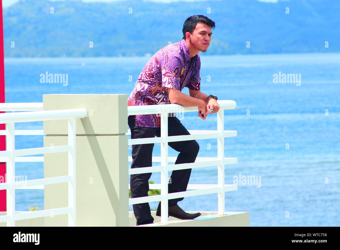 Man on railing hi-res stock photography and images - Alamy