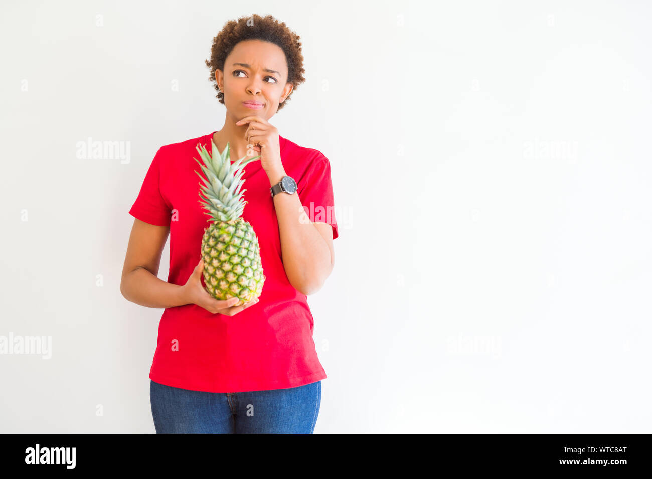 Young african american woman holding fresh healthy pineapple fruit ...