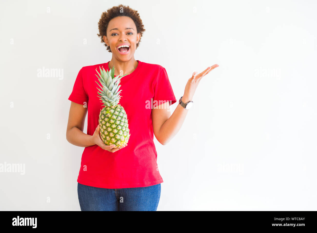 Young african american woman holding fresh healthy pineapple fruit very ...