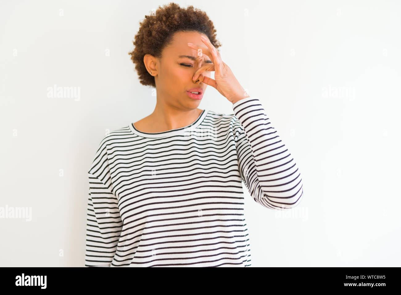 Young beautiful african american woman wearing stripes sweater over ...