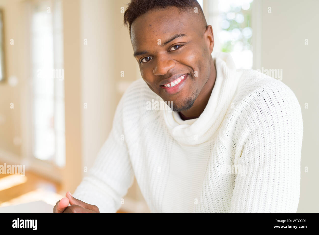 Handsome african young man smiling cheerful with a big smile on face ...