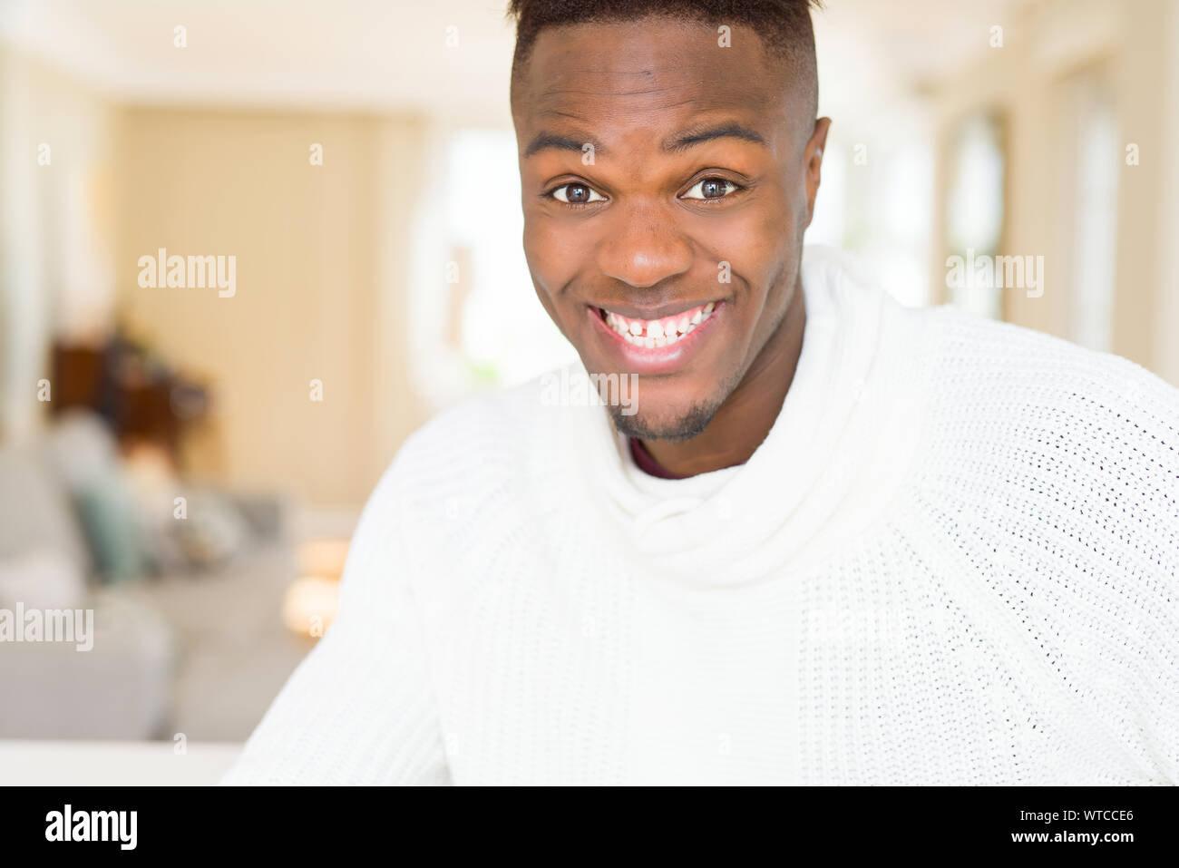 Handsome african young man smiling cheerful with a big smile on face ...