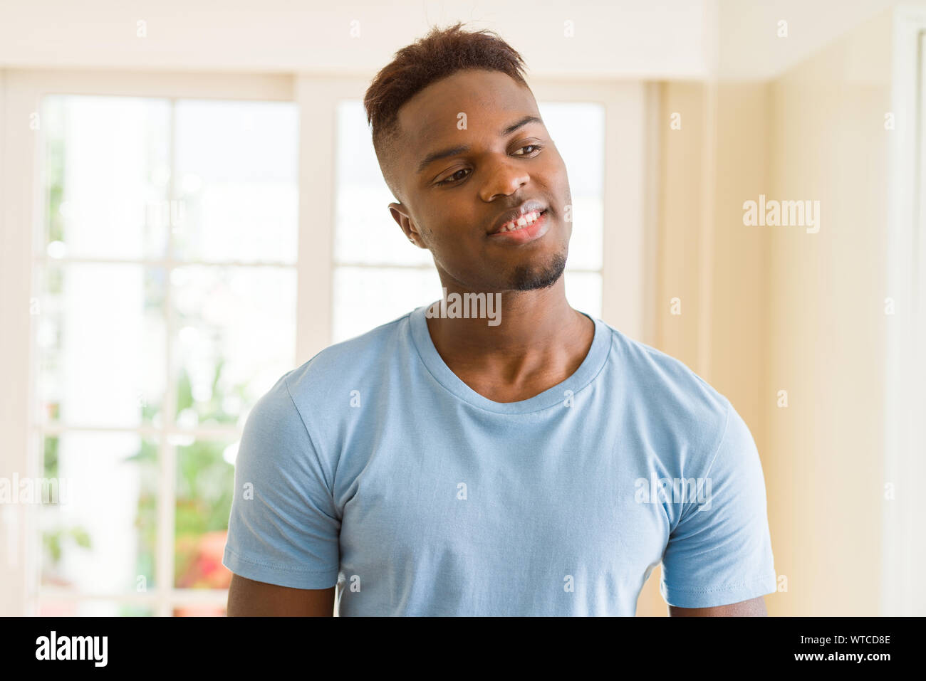 Handsome african young man smiling cheerful with a big smile on face ...