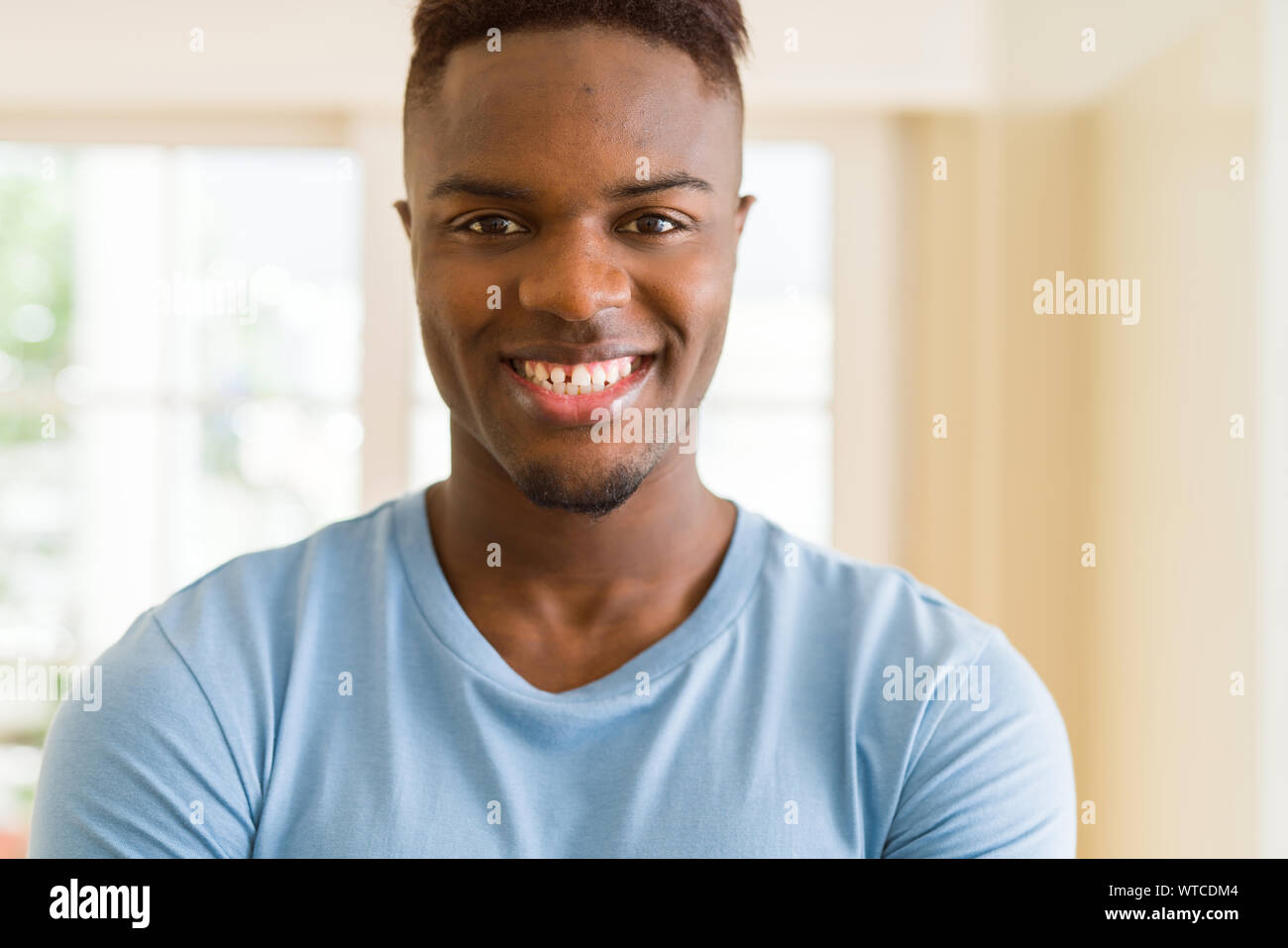 Handsome african young man smiling cheerful with a big smile on face ...