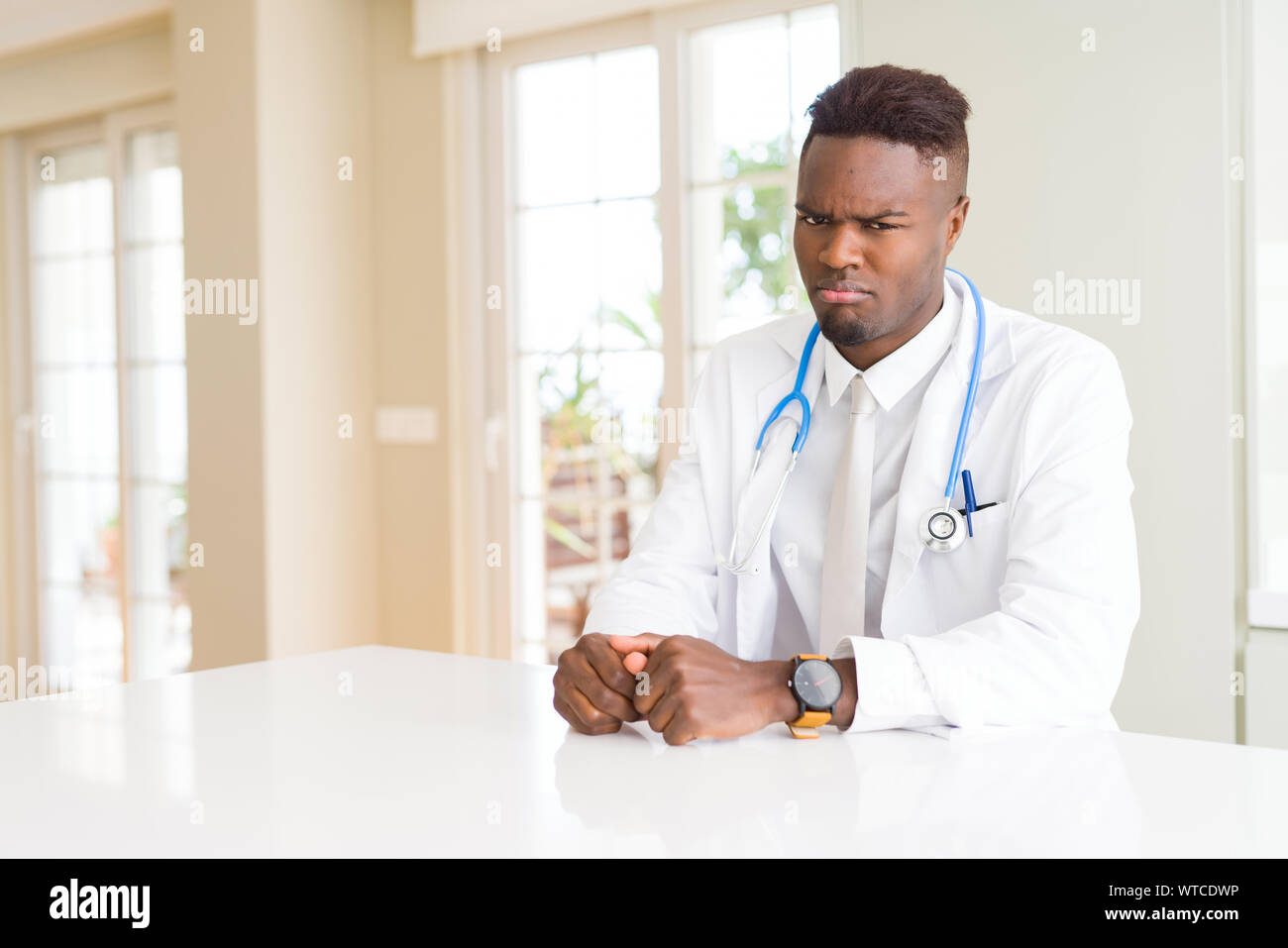 African american doctor man at the clinic depressed and worry for ...