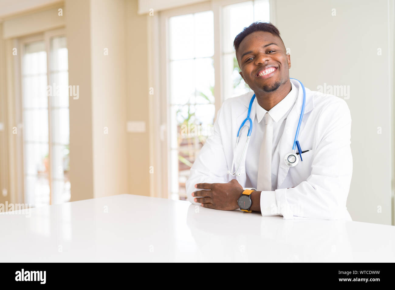 African american doctor man at the clinic happy face smiling with ...