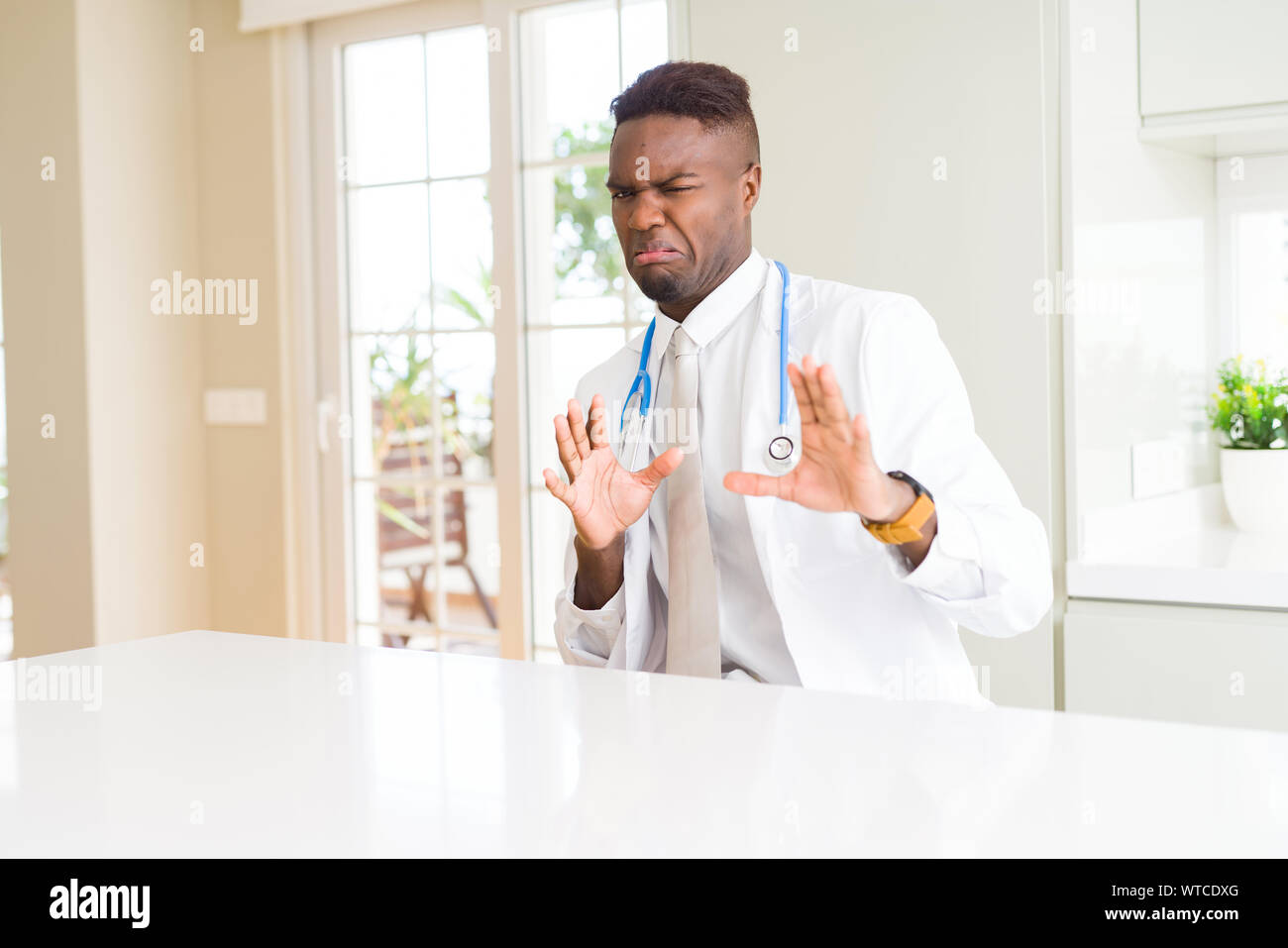 African american doctor man at the clinic disgusted expression ...