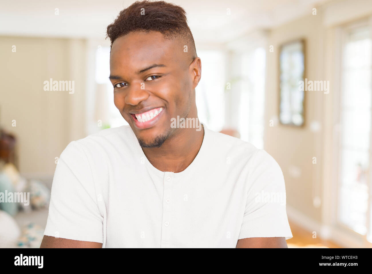 Handsome african young man smiling cheerful with a big smile on face ...