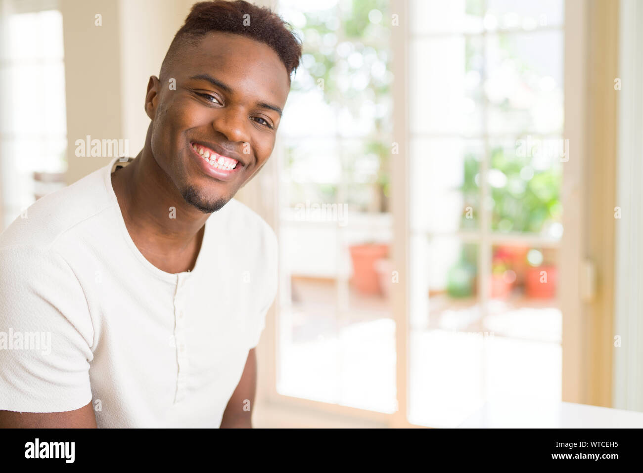 Handsome african young man smiling cheerful with a big smile on face ...
