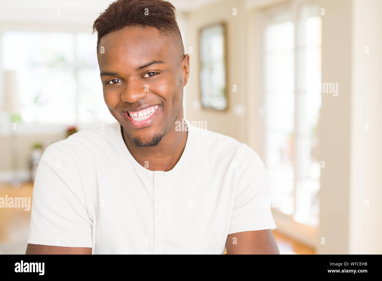 Handsome african young man smiling cheerful with a big smile on face ...