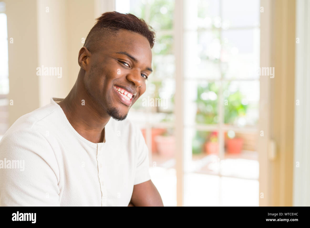 Handsome african young man smiling cheerful with a big smile on face ...