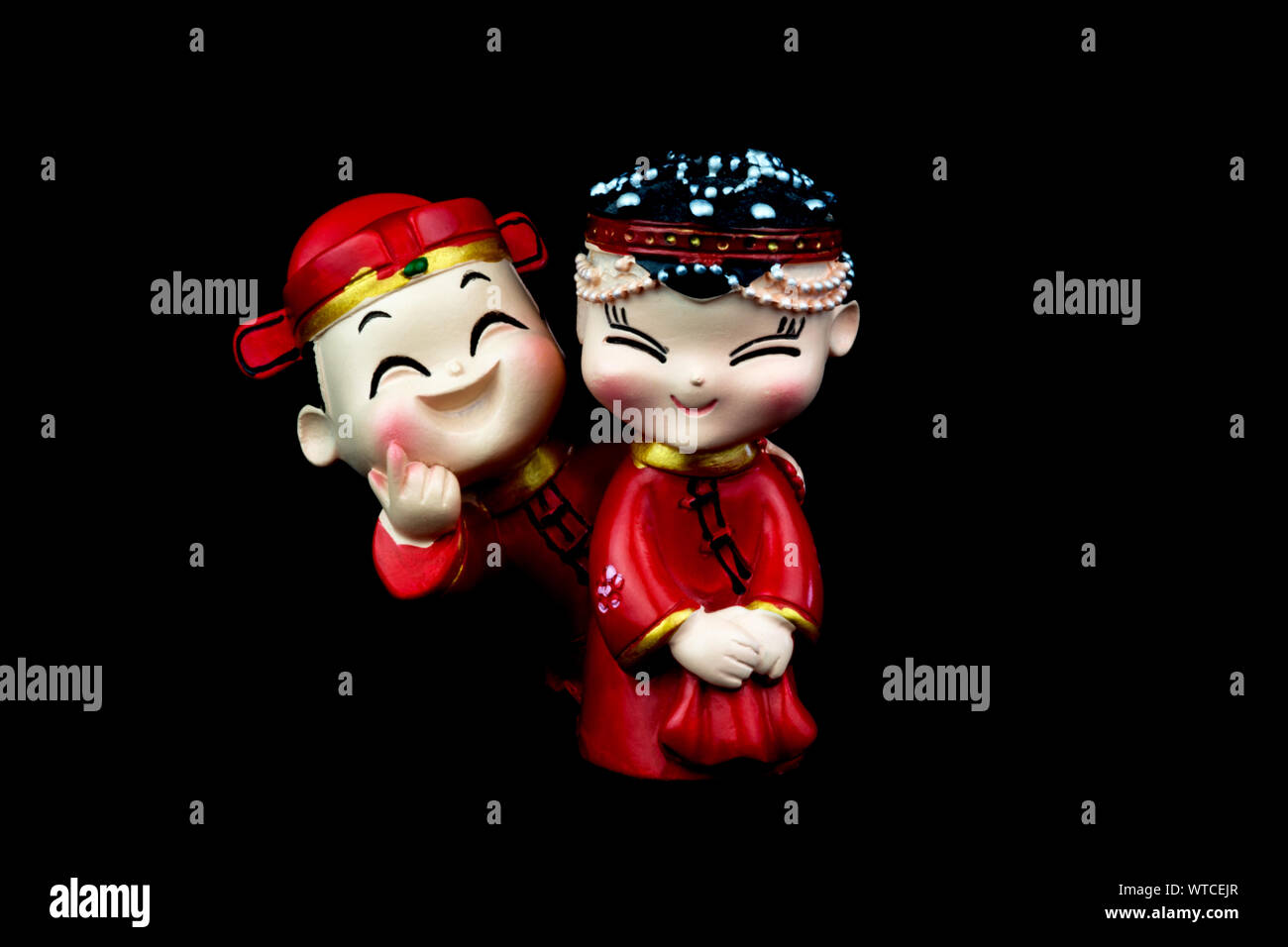 Small Chinese figurines isolated against a black background Stock Photo ...