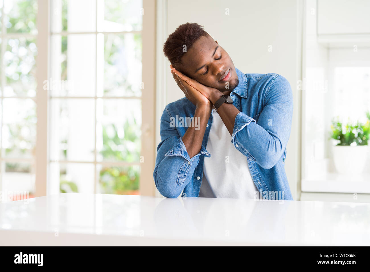 Handsome african american man at home sleeping tired dreaming and ...