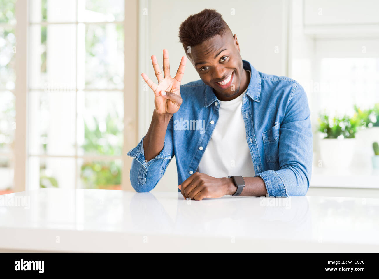 Handsome african american man at home showing and pointing up with ...