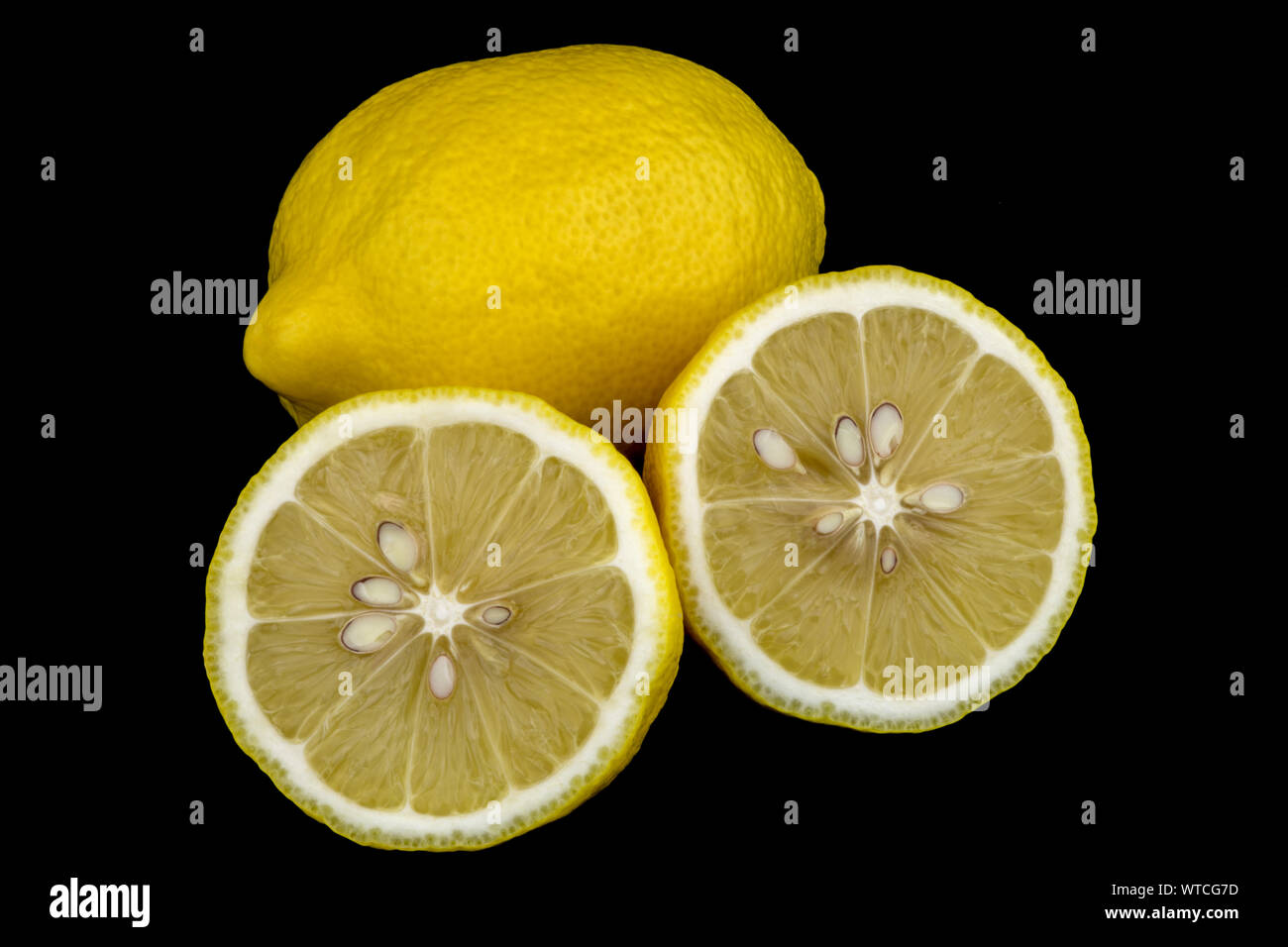 Whole and cut lemons isolated against a black background Stock Photo ...
